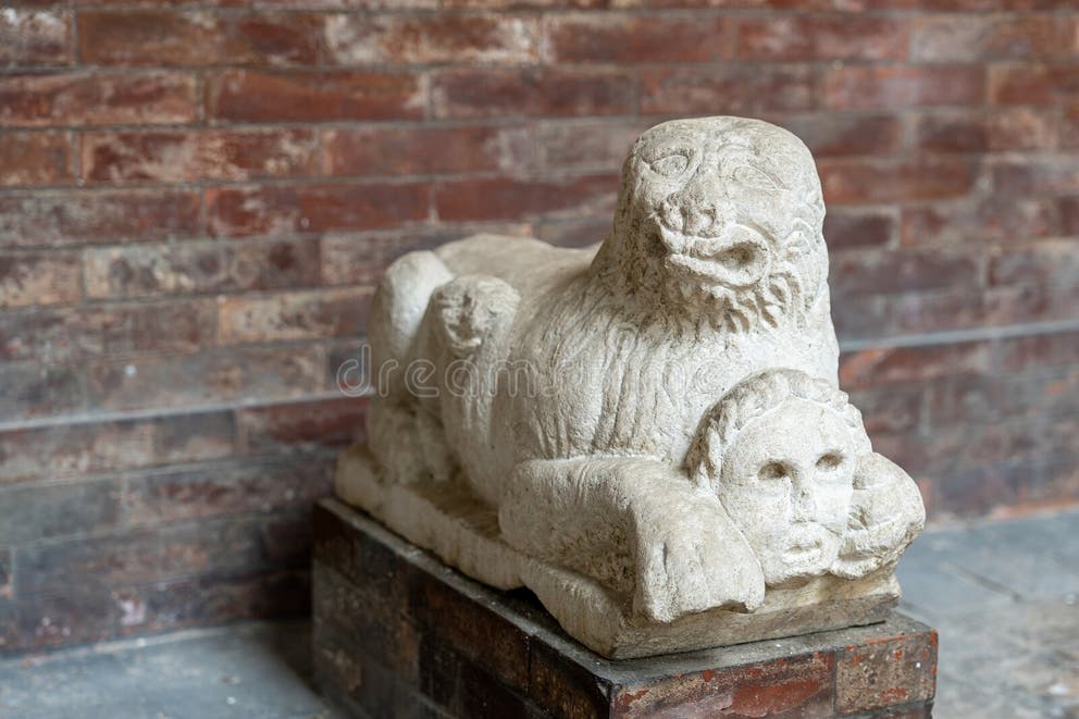 Ancient Stone Sculpture of Strange Beast Holding a Human Face Stock ...