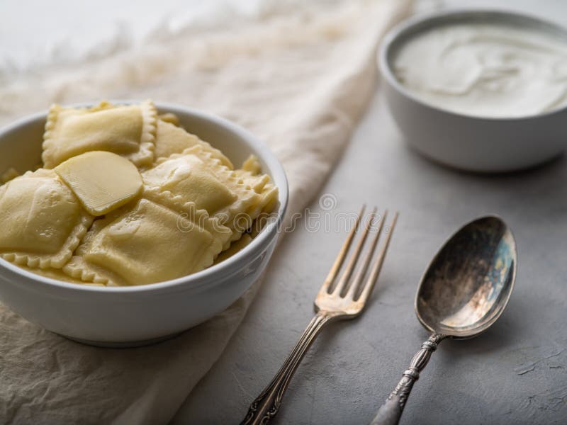 Ravioli or Dumplings with Sour Cream or Sauce on a Light Background ...