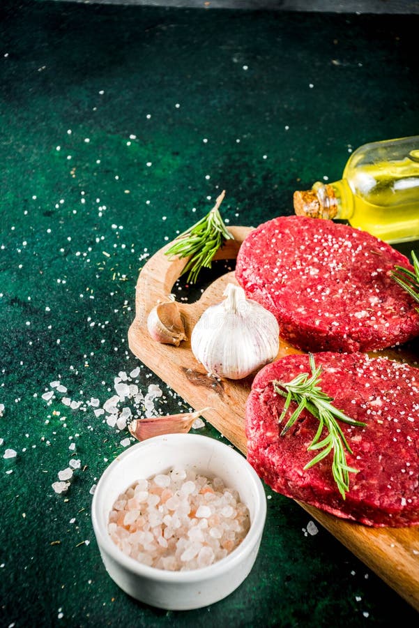 Raw beef burger cutlets stock image. Image of black - 145535189