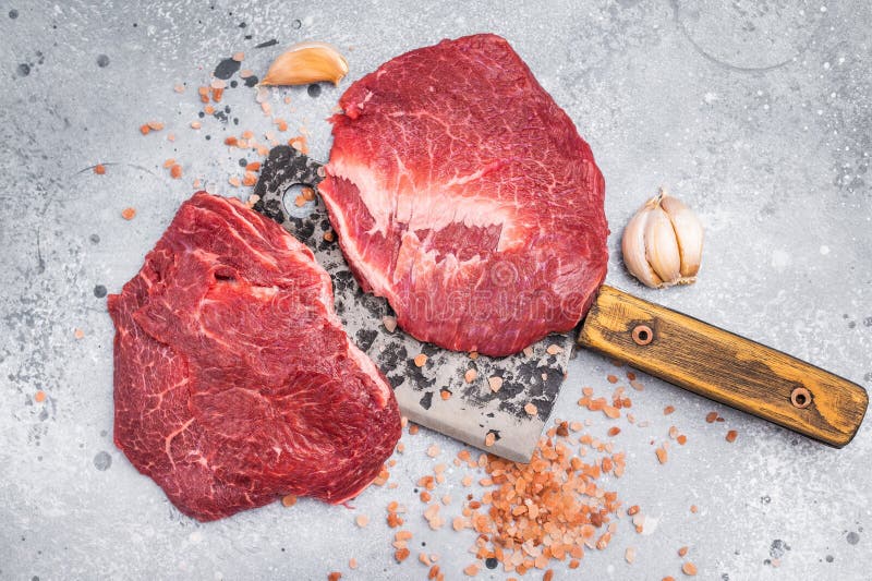 Raw Beef Cheeks on Butcher Meat Cleaver. Grey Background Stock Image ...