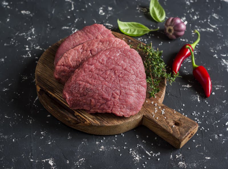 Raw Beef Chops on a Wooden Cutting Board Stock Image - Image of fillet ...