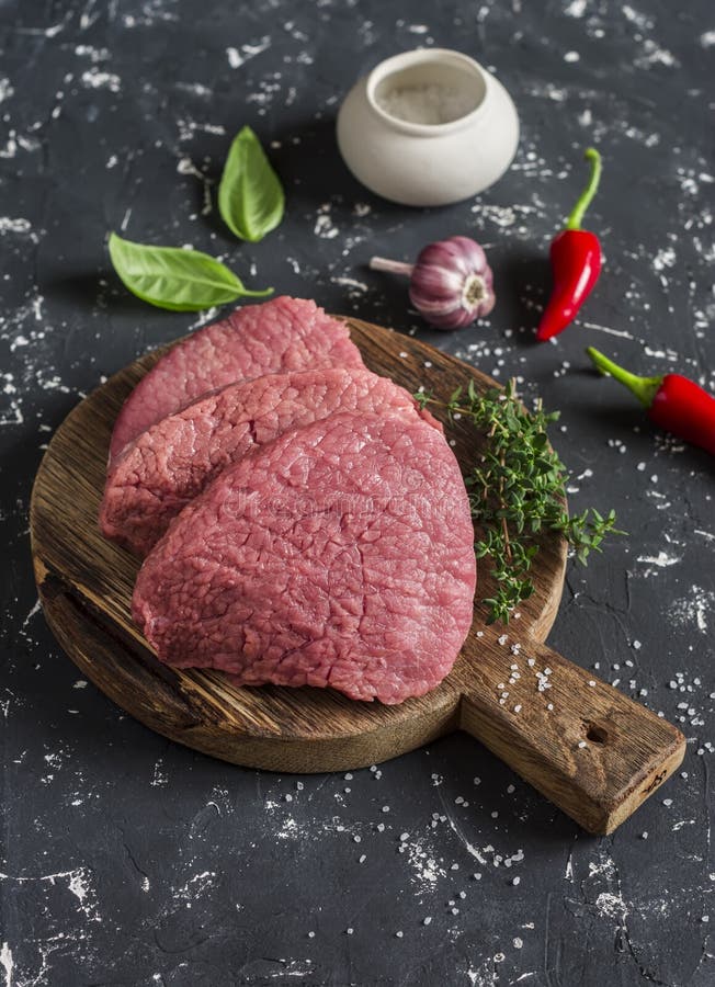 Raw Beef Chops on a Wooden Cutting Board Stock Photo - Image of organic ...