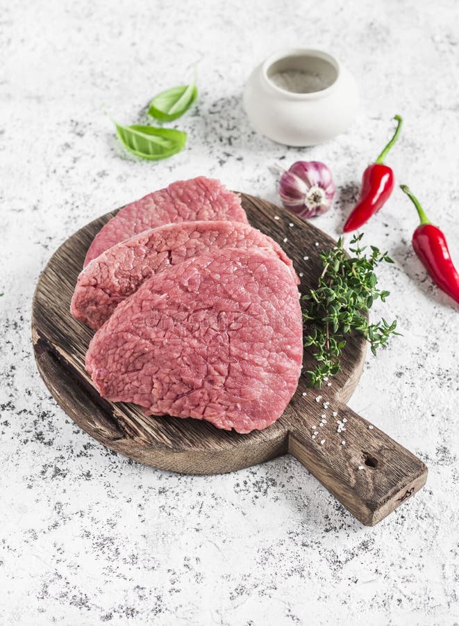 Raw Beef Chops on a Wooden Cutting Board Stock Photo - Image of ...