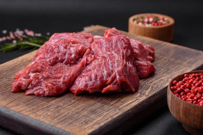 Raw Beef Cut into Several Pieces on a Wooden Cutting Board Stock Image ...