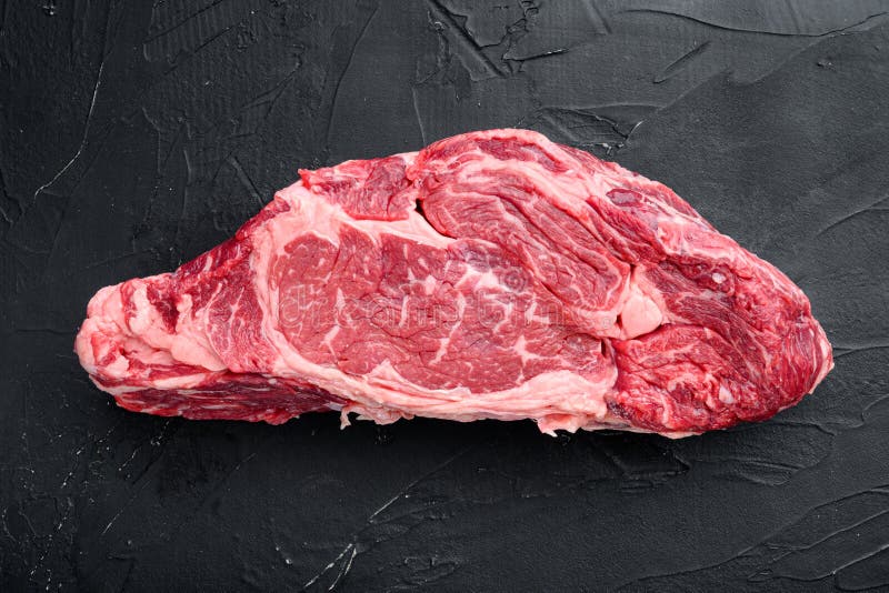 Raw Beef Meat , on Black Stone Background, Rib Eye Cut, Top View Flat ...