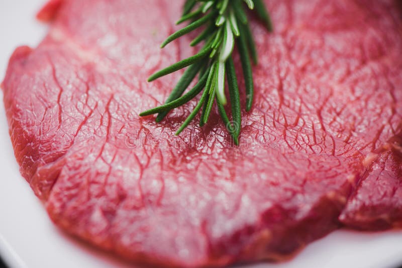 Raw Beef Meat on a Plate on Dark Table. Stock Image - Image of meal ...