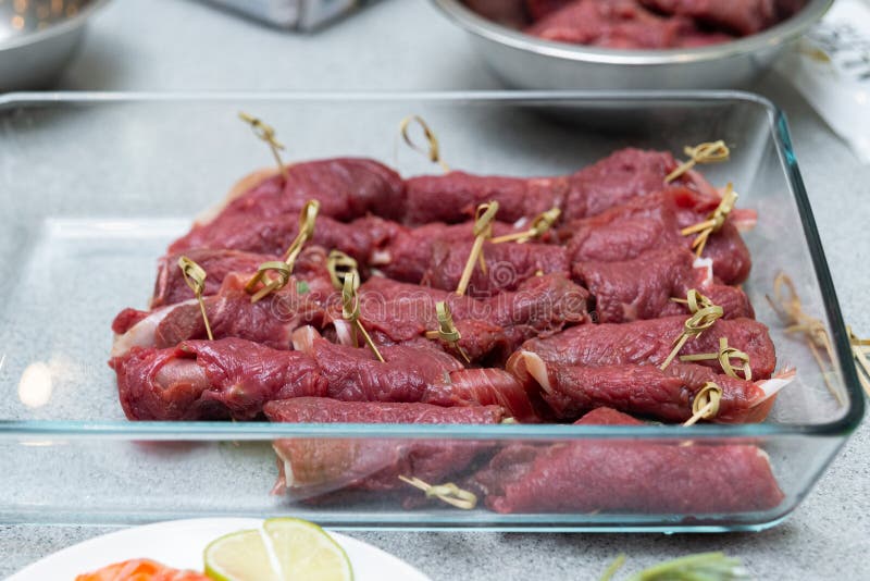 Raw Beef Meat Rolls with Spices and Herbs in a Glass Tray Stock Photo ...