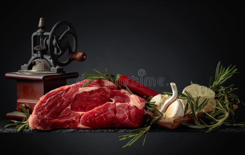 Raw Beef Meat Steaks with Rosemary, Garlic, and Pepper Stock Photo ...