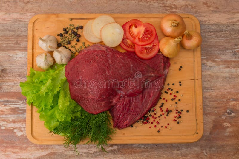 Raw Beef Meat with Vegetables on Wooden Plate. Stock Image - Image of ...