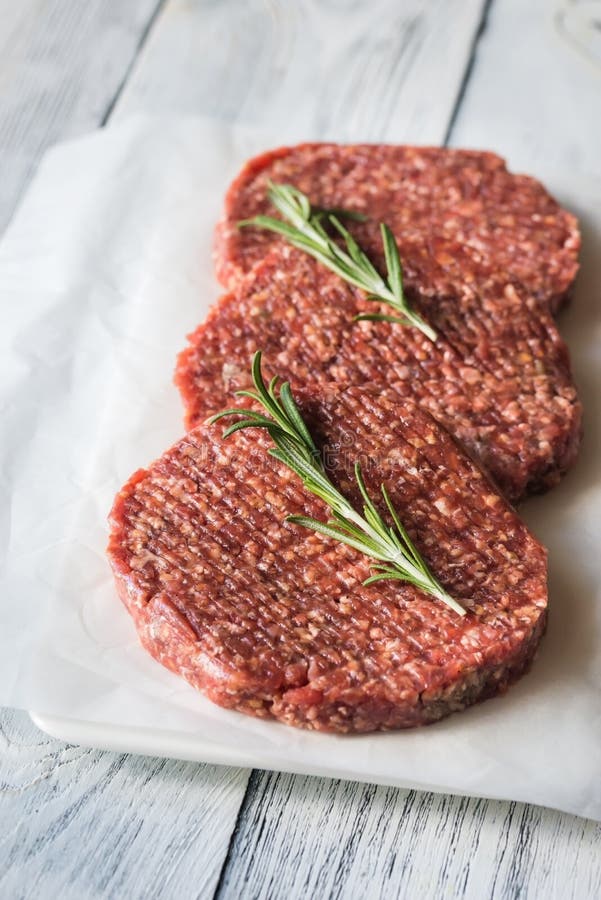 Raw Beef Patties on the White Parchment Stock Photo - Image of food ...