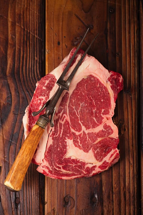Raw Beef Ribeye Steak on Wooden Table Stock Photo - Image of fresh ...