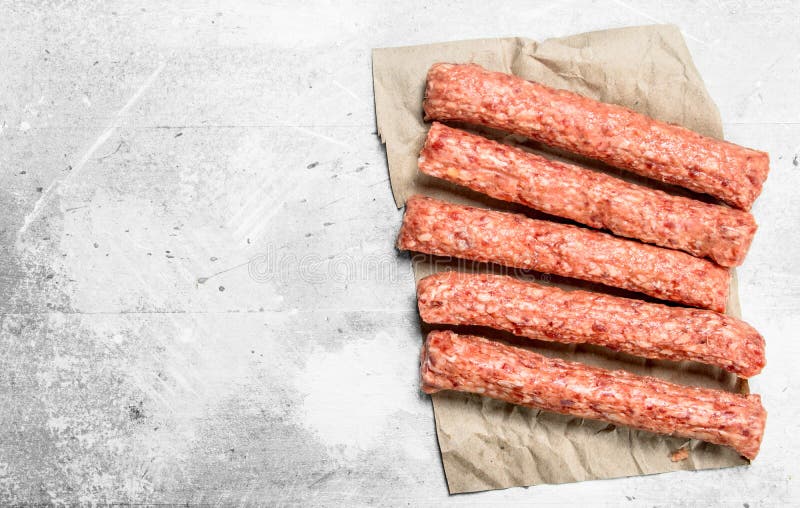Raw beef sausages on paper stock photo. Image of appetizer - 141920158