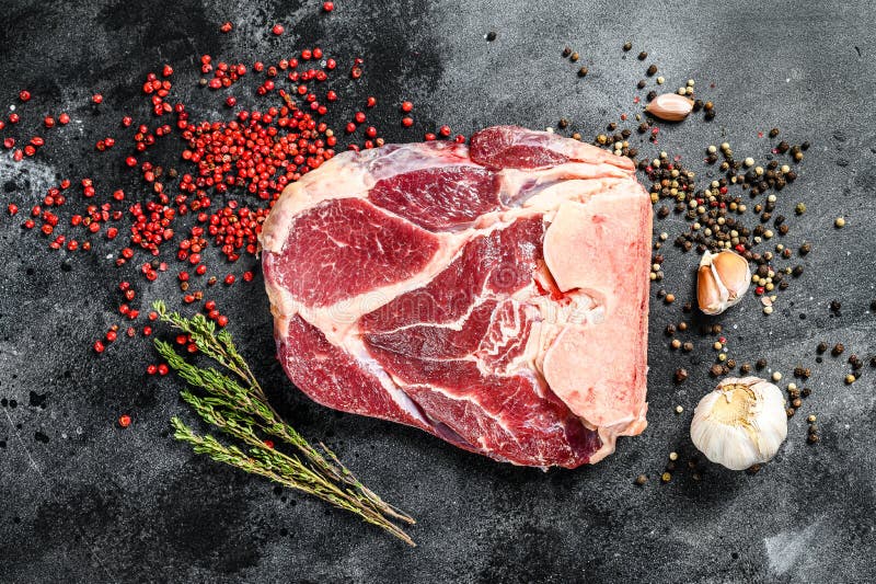 Raw Beef Shank with Spices and Herbs. Black Background Stock Photo ...