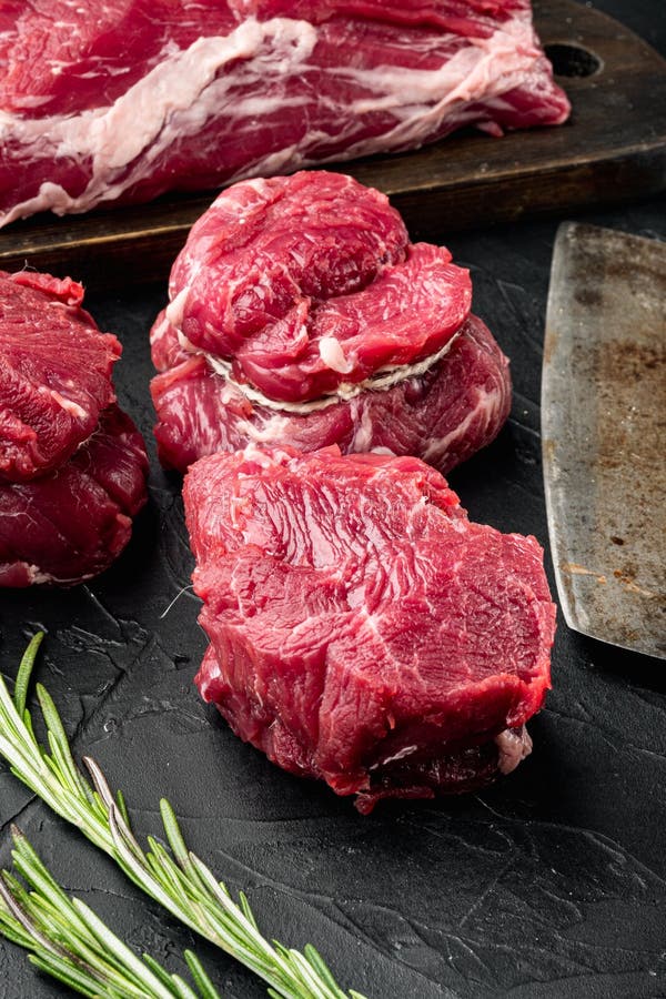 Raw Beef Steak, Filet Mignon Cut, on Black Stone Background Stock Photo ...