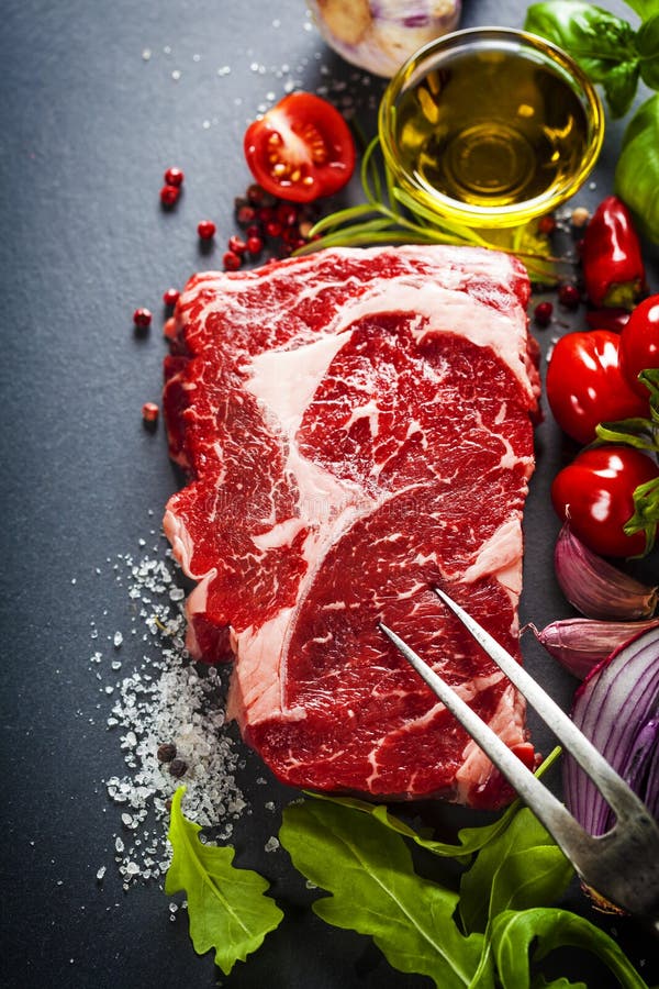 Raw Beef Steak on Black Background with Cooking Ingredients. Fresh Beef ...