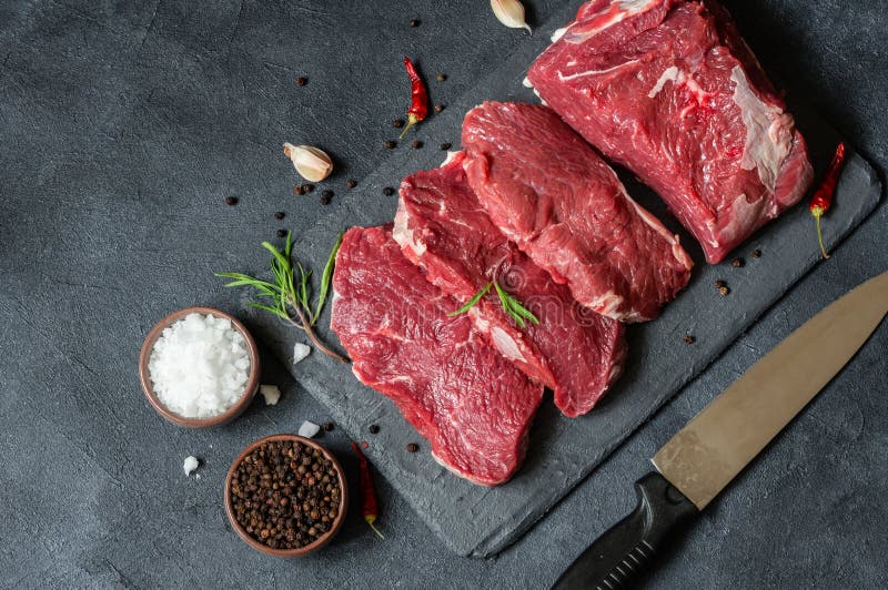 Raw Beef Steak Meat on Stone Board with Thyme and Peppers Stock Image ...