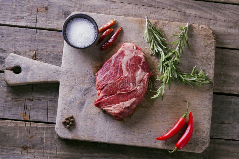 Raw Beef Steak and Spices on Wooden Table. Top View. Stock Image ...