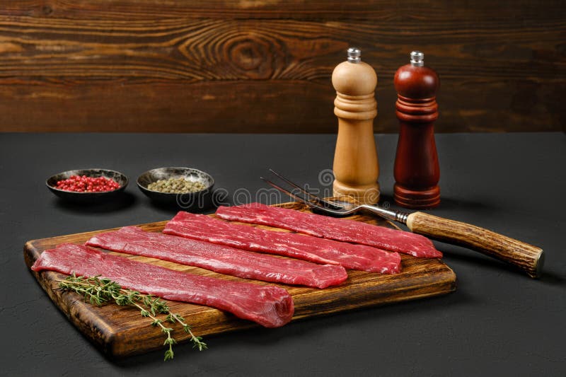 Raw Beef Strips on Cutting Board Stock Photo - Image of meat, kobe ...