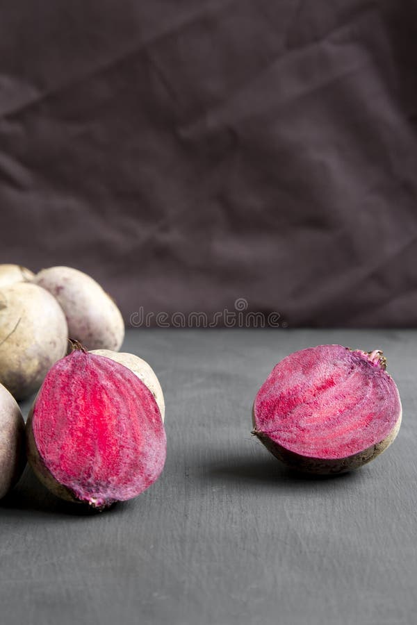 Raw Beetroot and Two Halves on Black Surface, Side View. Stock Photo ...