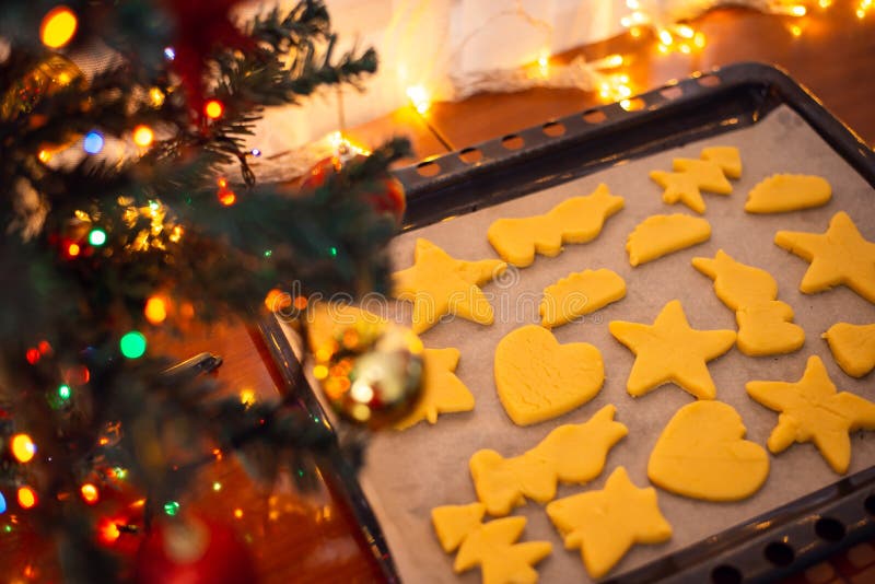 Raw Biscuits on the Baking Tray Near Decorated Christmas Tree before ...