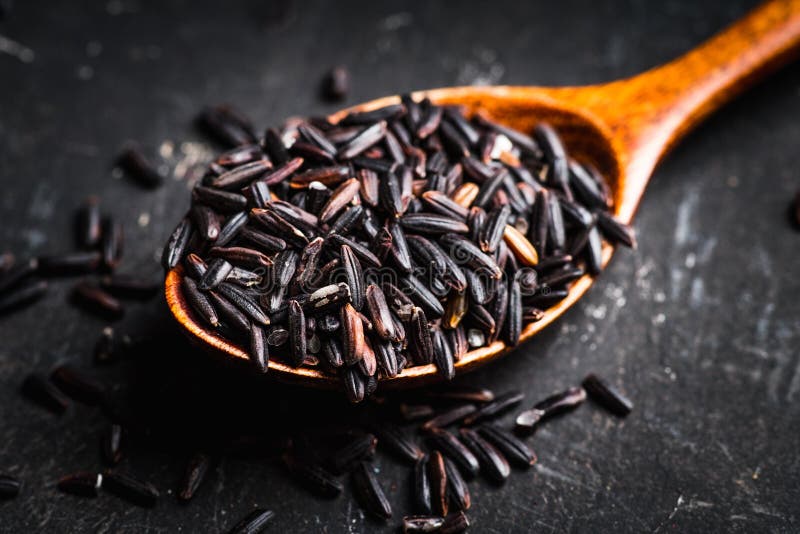 Raw Black Rice on the Dark Rustic Background Stock Photo - Image of ...