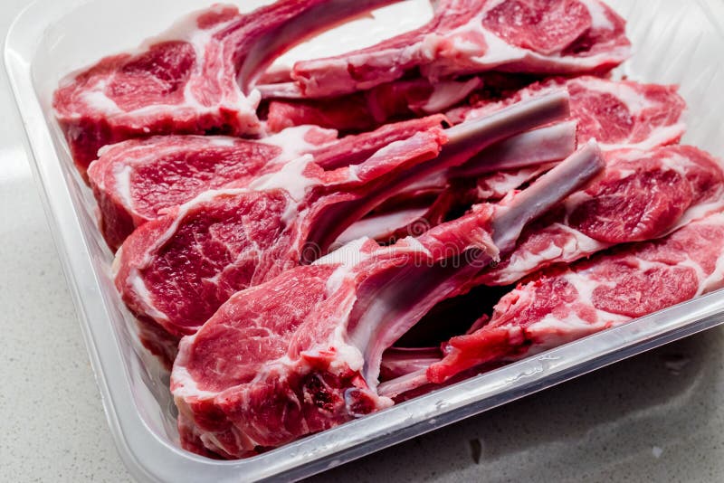Raw Bloody Lamb Chops Meat in Plastic Package / Box or Container Stock ...