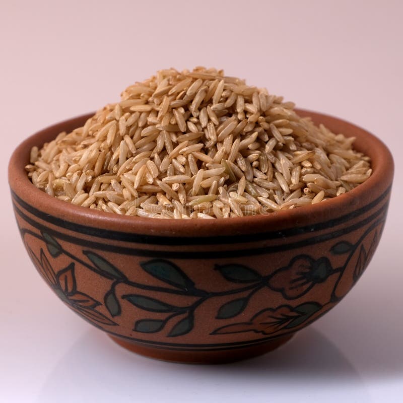Raw brown rice in a bowl stock image. Image of pile - 204371843