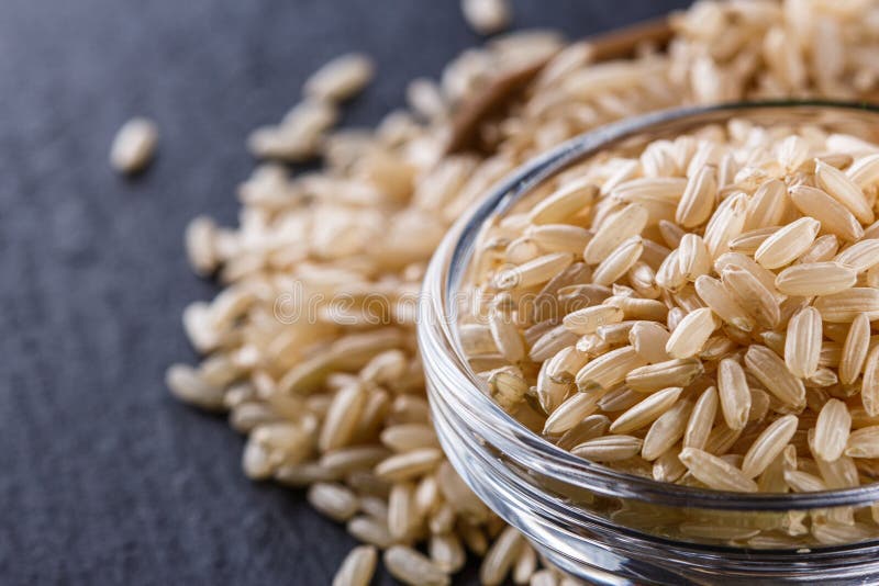 Raw Brown Rice on a Dark Stone Background Stock Image - Image of ...