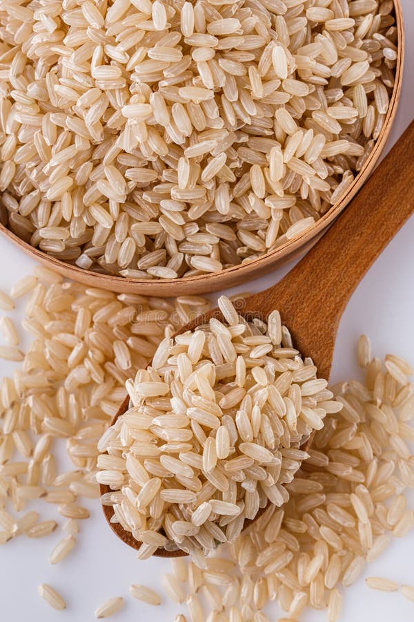 Raw Brown Rice on White Acrylic Background Stock Photo - Image of ...