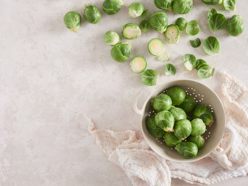 Raw Brussels Sprouts on a Colander, Several Spread Out on the Kitchen ...