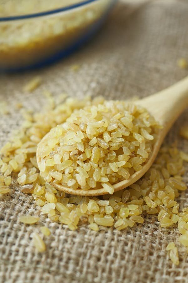 Raw Bulgur Rice on Wooden Spoon , Stock Image - Image of grain, food ...