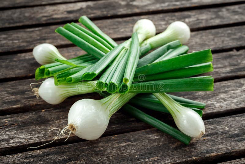 Raw Bunch of Fresh Spring Onion on Rustic Wooden Table Stock Photo ...
