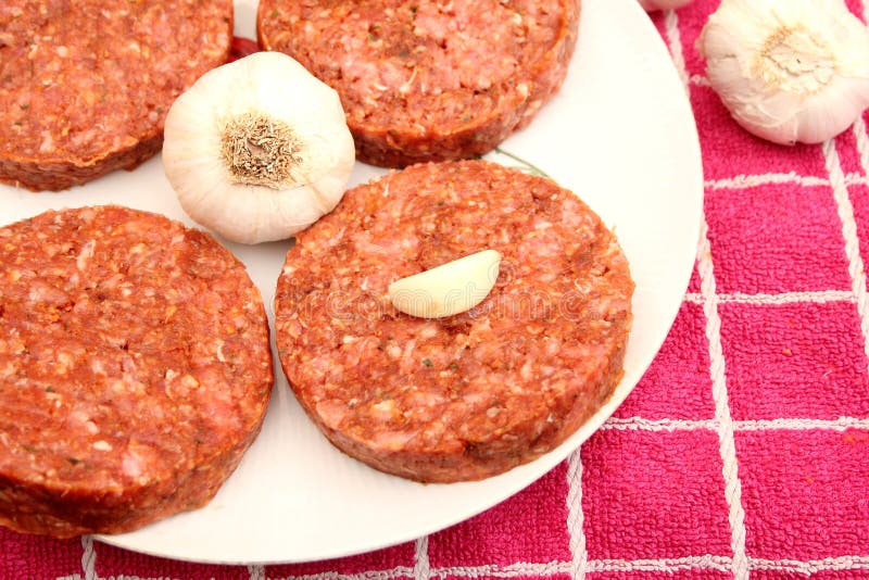 Raw Burger Patties with Garlic Stock Image - Image of burger, garlic ...