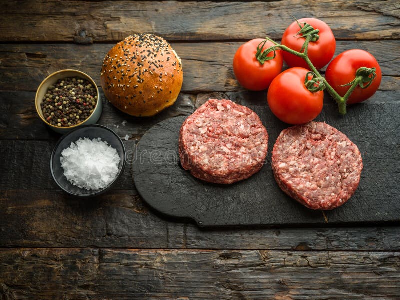 Raw Burger Patties Over a Wood Table Stock Image - Image of restaurant ...