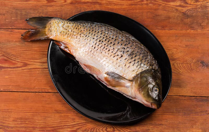 Raw Carp Prepared for Cooking on Dish on Rustic Table Stock Photo ...