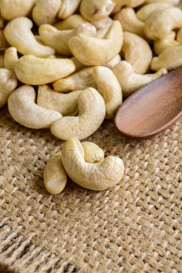 Raw Cashew Nuts with Wooden Spoon Stock Photo - Image of background ...