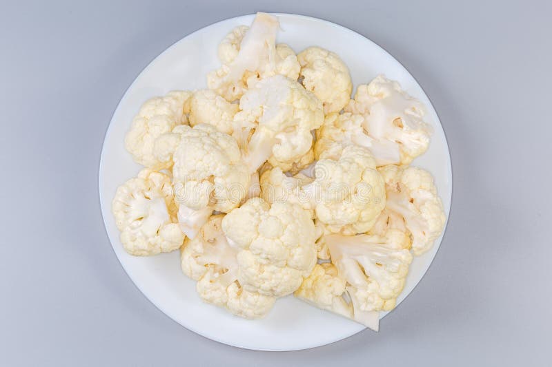 Raw Cauliflower Pieces on Dish on Gray Background, Top View Stock Image ...
