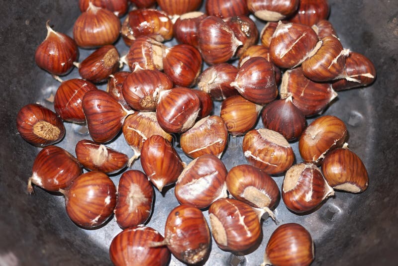 Raw Chestnuts in a pan stock image. Image of heap, fried - 108064087
