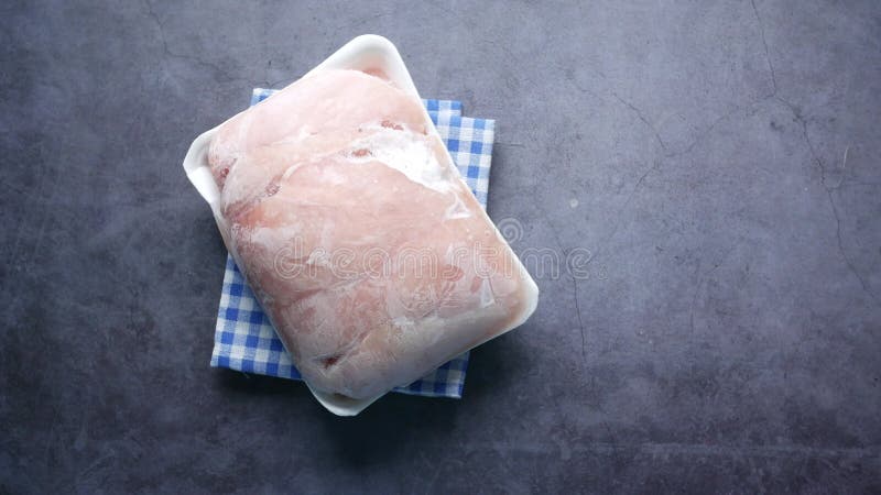Overhead View of Raw Chicken Breast in a Packet on Black Background ...