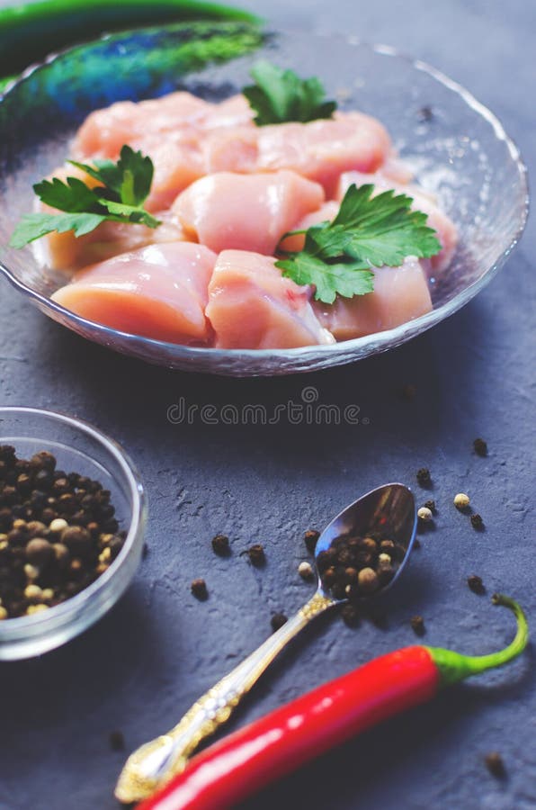 Raw Chicken Cubes in Bowl on Dark Stone Table. Breast Cubes. Soft ...
