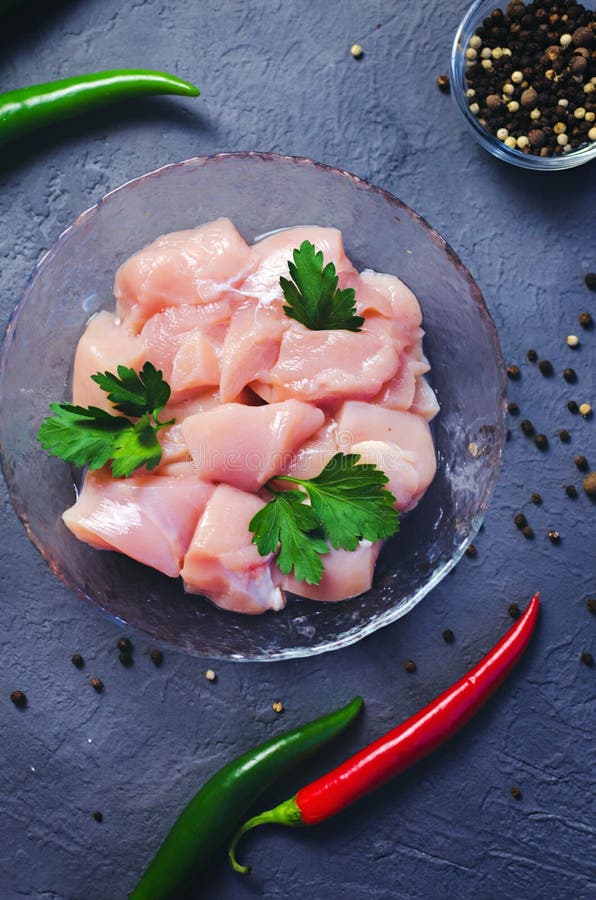 Raw Chicken Cubes in Bowl on Dark Stone Table. Breast Cubes Stock Image ...
