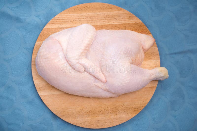 Raw Chicken on the Cutting Board on Wooden Background and Blue ...