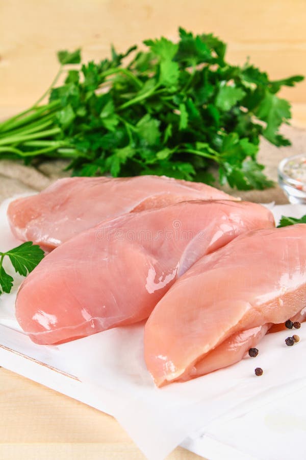 Raw Chicken Fillets on Wooden Cutting Board. Stock Photo - Image of ...