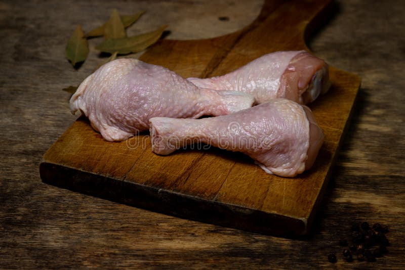 Raw Chicken Legs on a Wooden Board. Chicken Legs on an Old Wooden ...