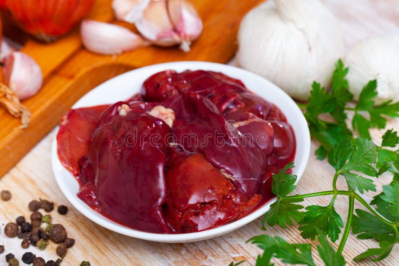 Raw Chicken Chicken Liver on Wooden Surface and Greens Stock Photo ...