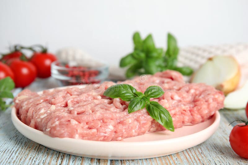 Raw Chicken Minced Meat with Basil on Light Blue Wooden Table, Closeup ...