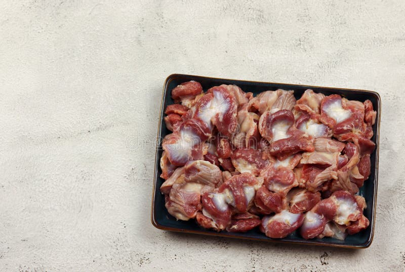 Raw Chicken Stomachs on a Rectangular Plate on a Light Gray Background ...