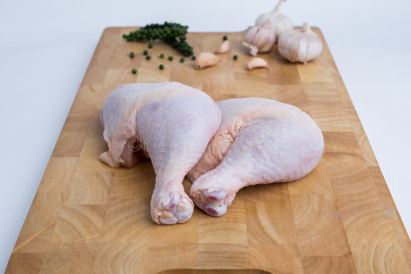 Raw Chicken Quarters, Legs with Herb on Cutting Board Stock Photo ...