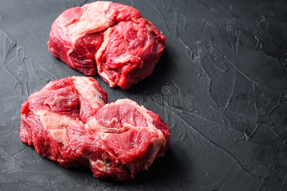 Raw Chuck Eye Roll Steak Cuts, Side View on Black Textured Table with ...