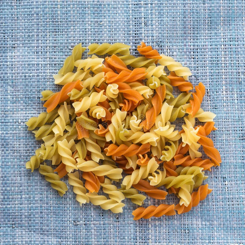 Multicolor Spiral Macaroni a Handful of Macaroni on a Rustic Blue ...